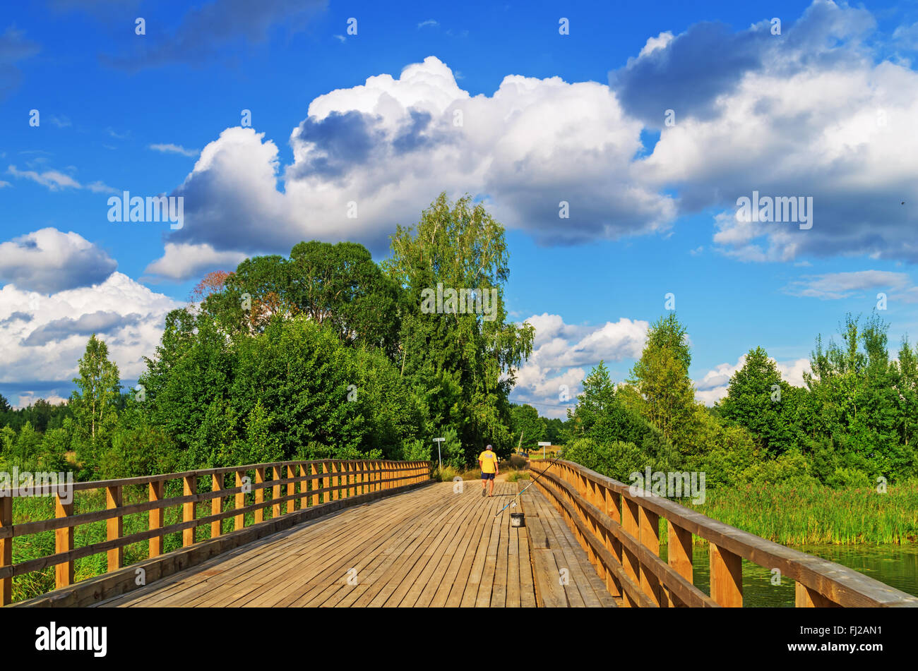 Village landscape with wooden bridge Stock Photo - Alamy
