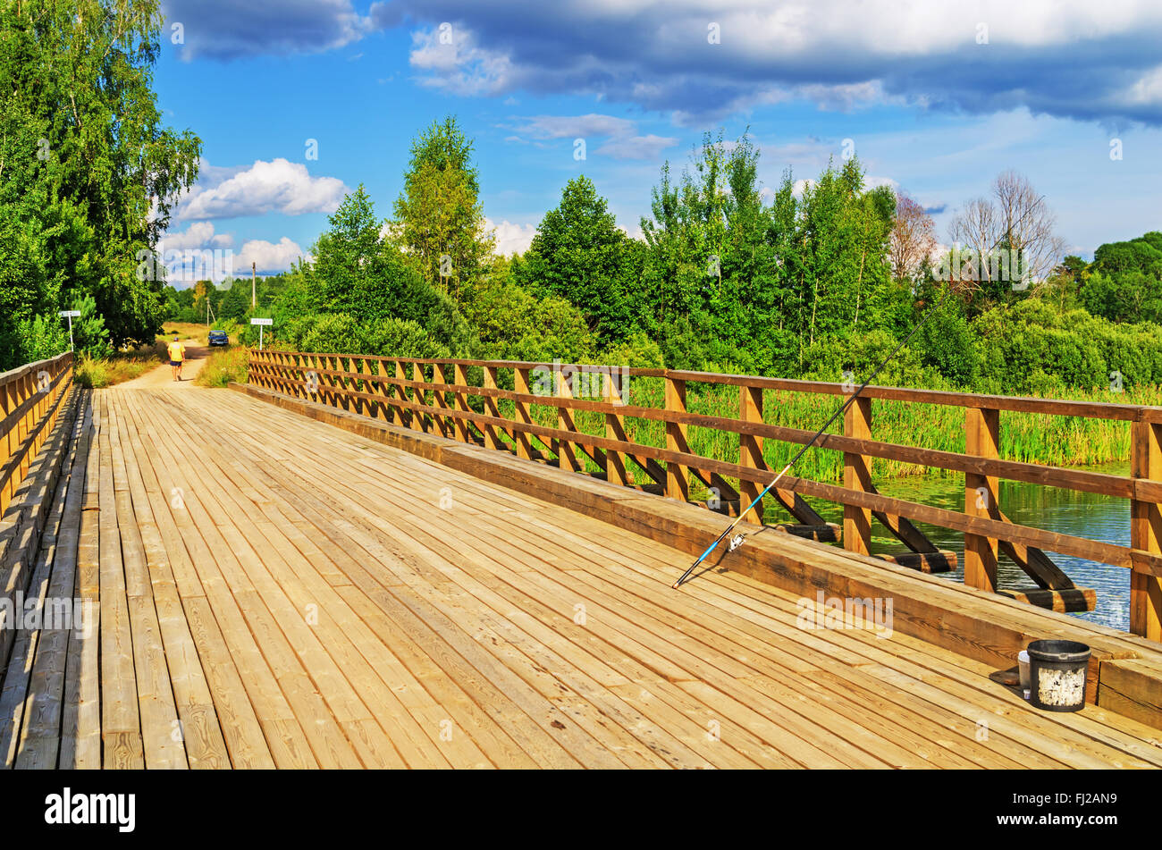 Village landscape with wooden bridge Stock Photo - Alamy