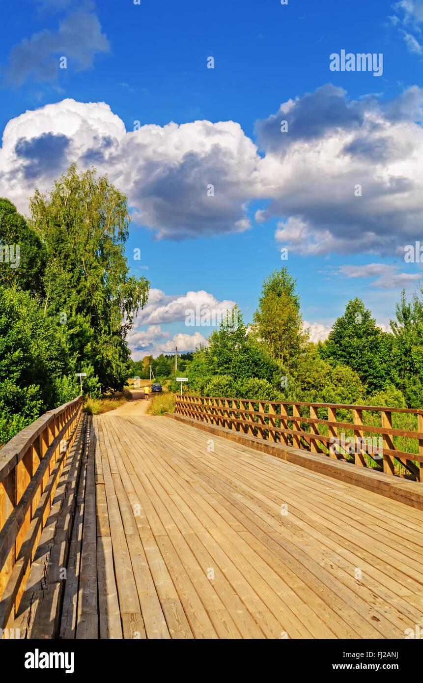 Village landscape with wooden bridge Stock Photo - Alamy