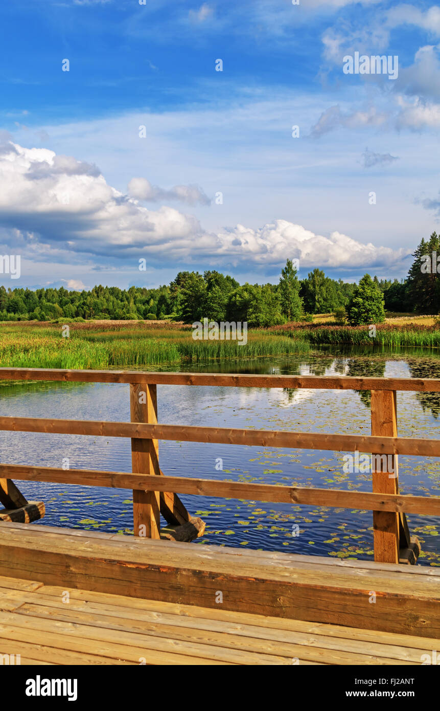 Village landscape with wooden bridge Stock Photo - Alamy