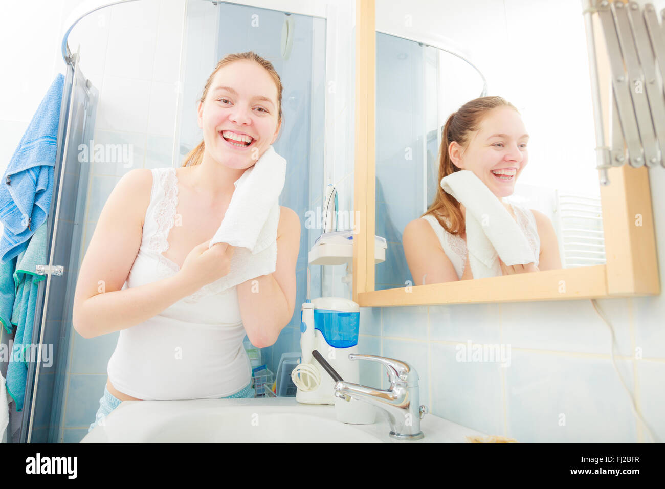 Morning hygiene. Woman cleaning washing her face with clean water in ...