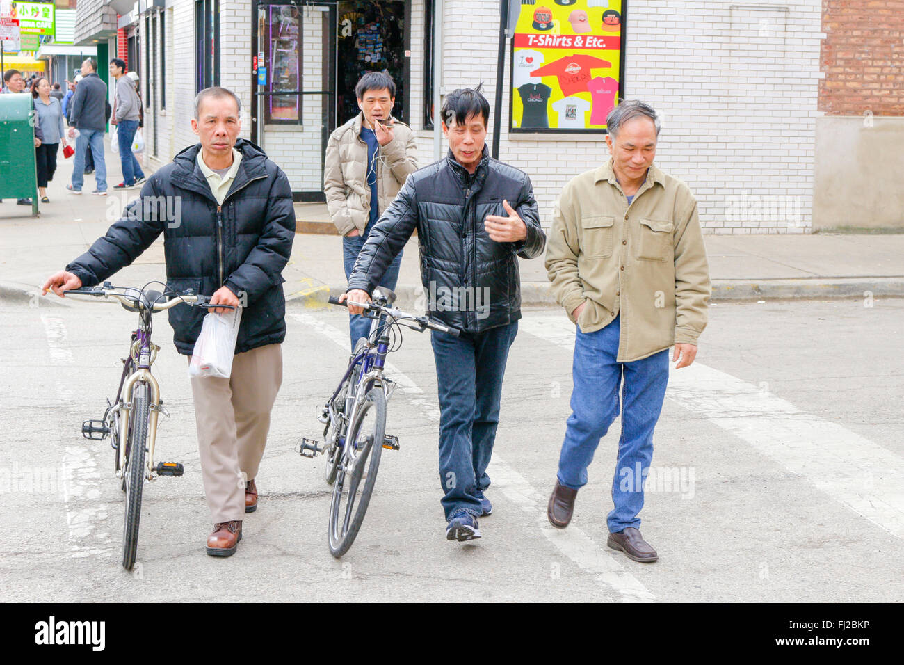 Men walking and talking, two with bicycles. Wentworth Avenue, Chinatown, Chicago, Illinois Stock ...