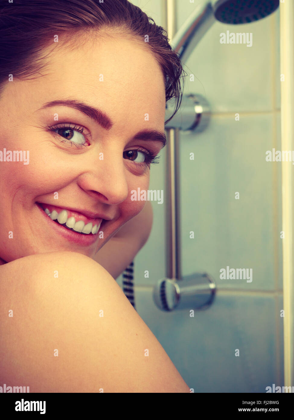 Girl showering in shower cabin cubicle enclosure. Young woman taking ...