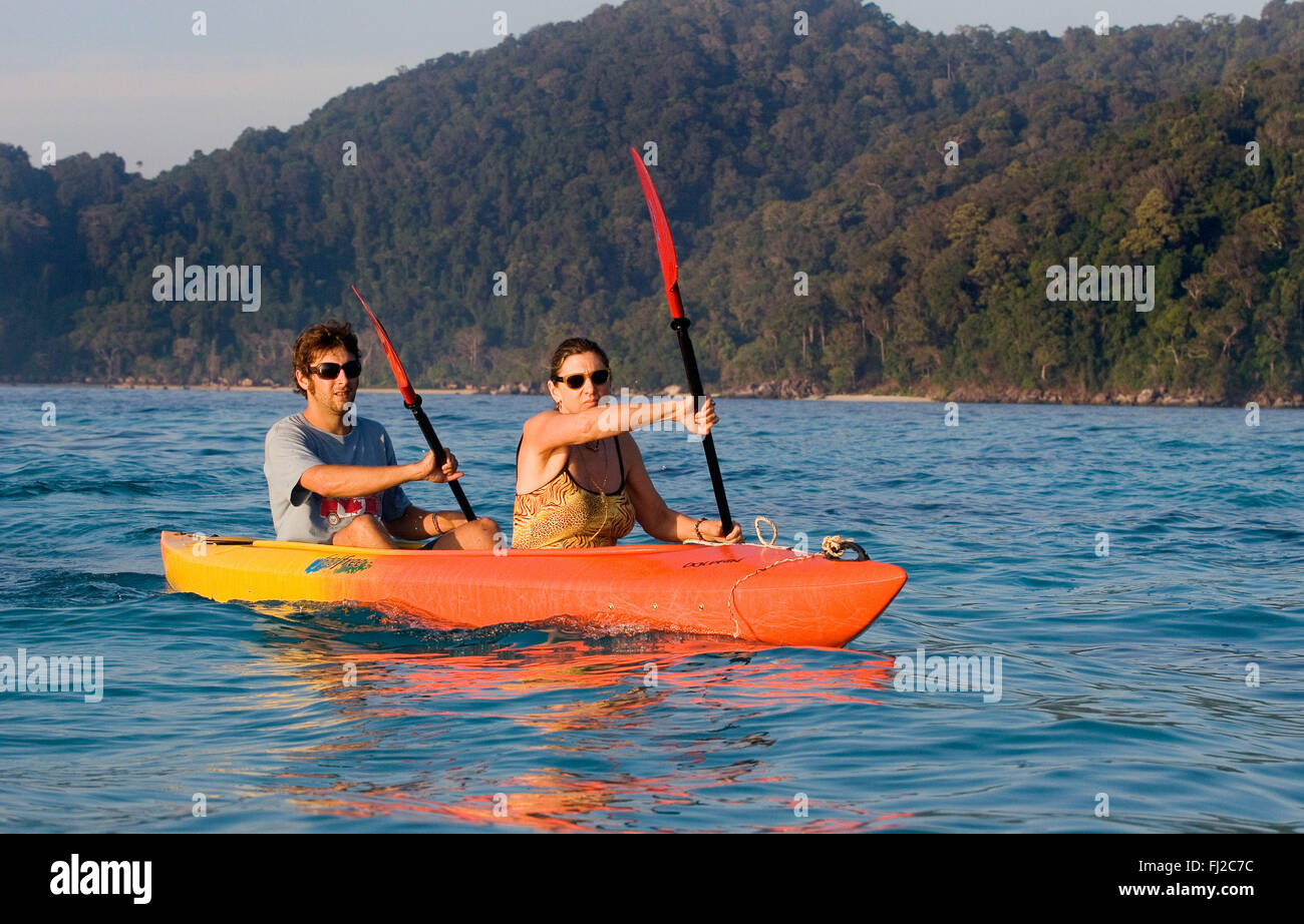 Travelers enjoy an early morning kayak paddle in the North Andaman Sea ...