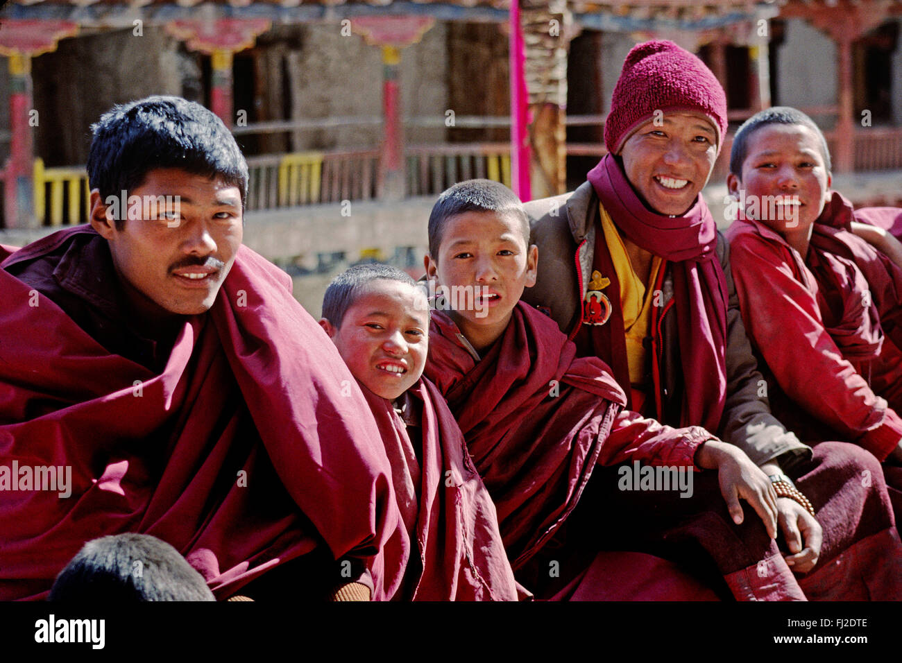 YOUNG MONKS sit in an upper courtyard of HEMIS GOMPA (monastery ...