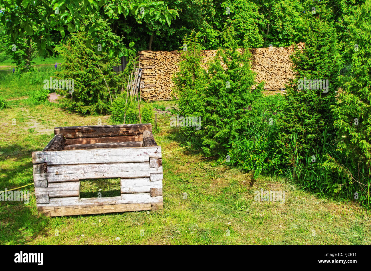 Spring. Old log cabin - wooden base for furnace. Furnace inside wooden ...