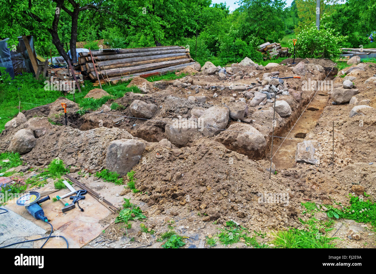 Construction of rural house foundation with use of natural boulders ...