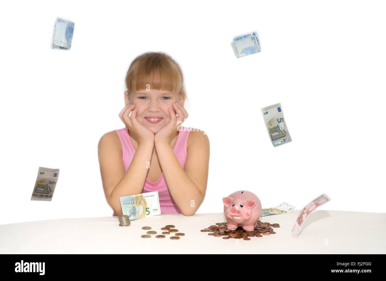 Cheerful little girl with flying money around isolated Stock Photo - Alamy