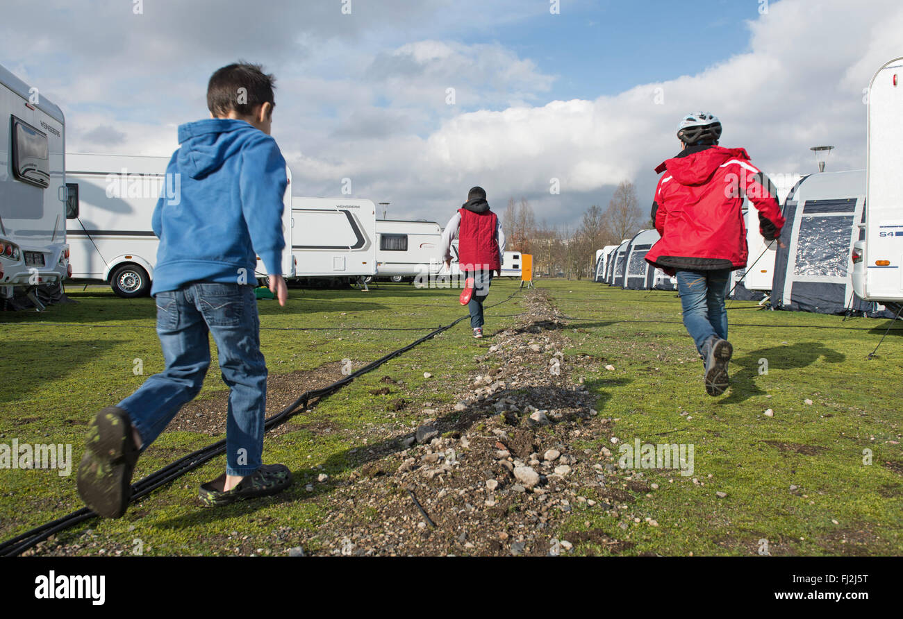 Refugee children from various countries play in a caravan park in ...