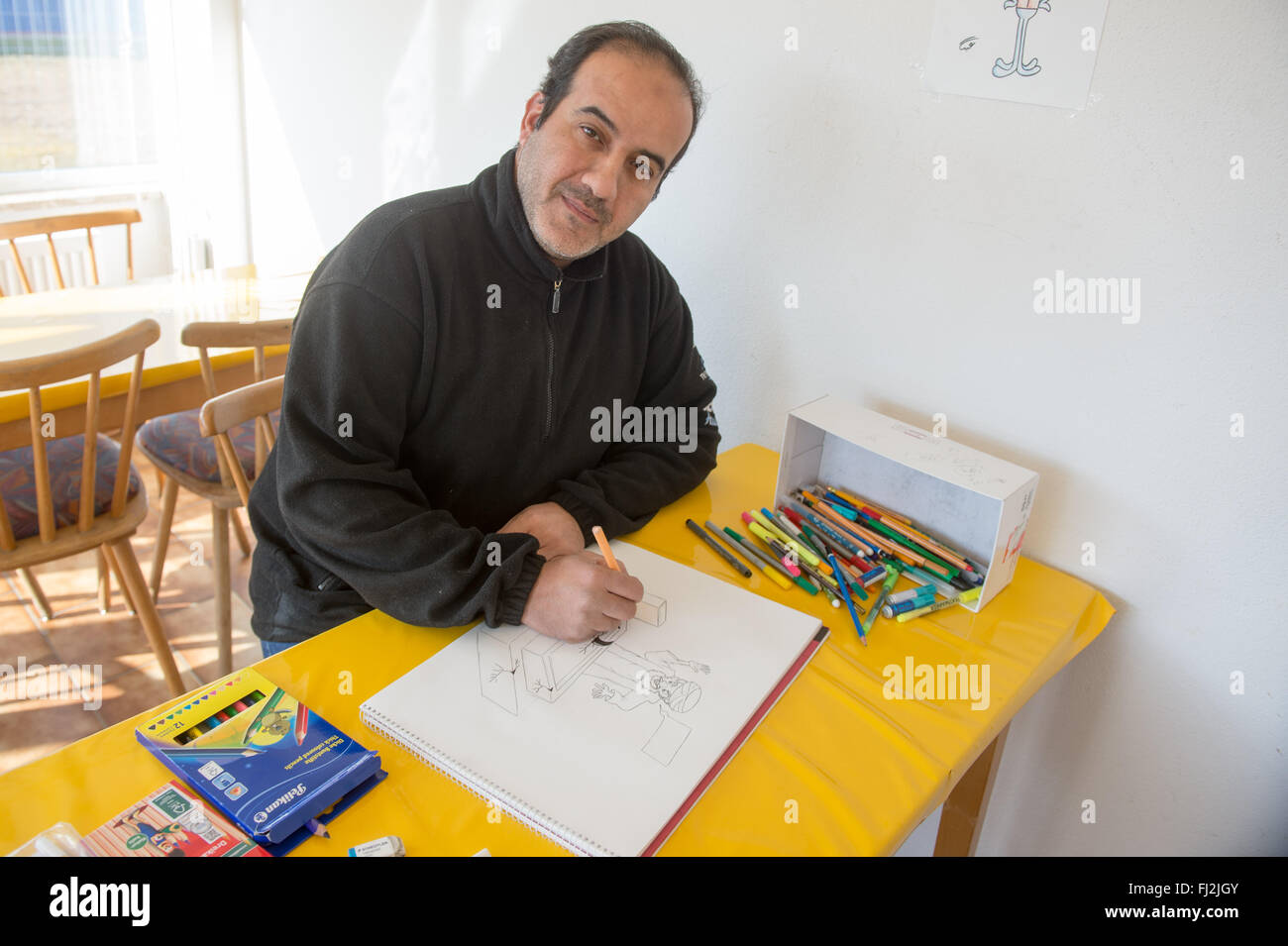 Viechtach, Germany. 26th Feb, 2016. Syrian cartoonist Ali Abdo draws in ...