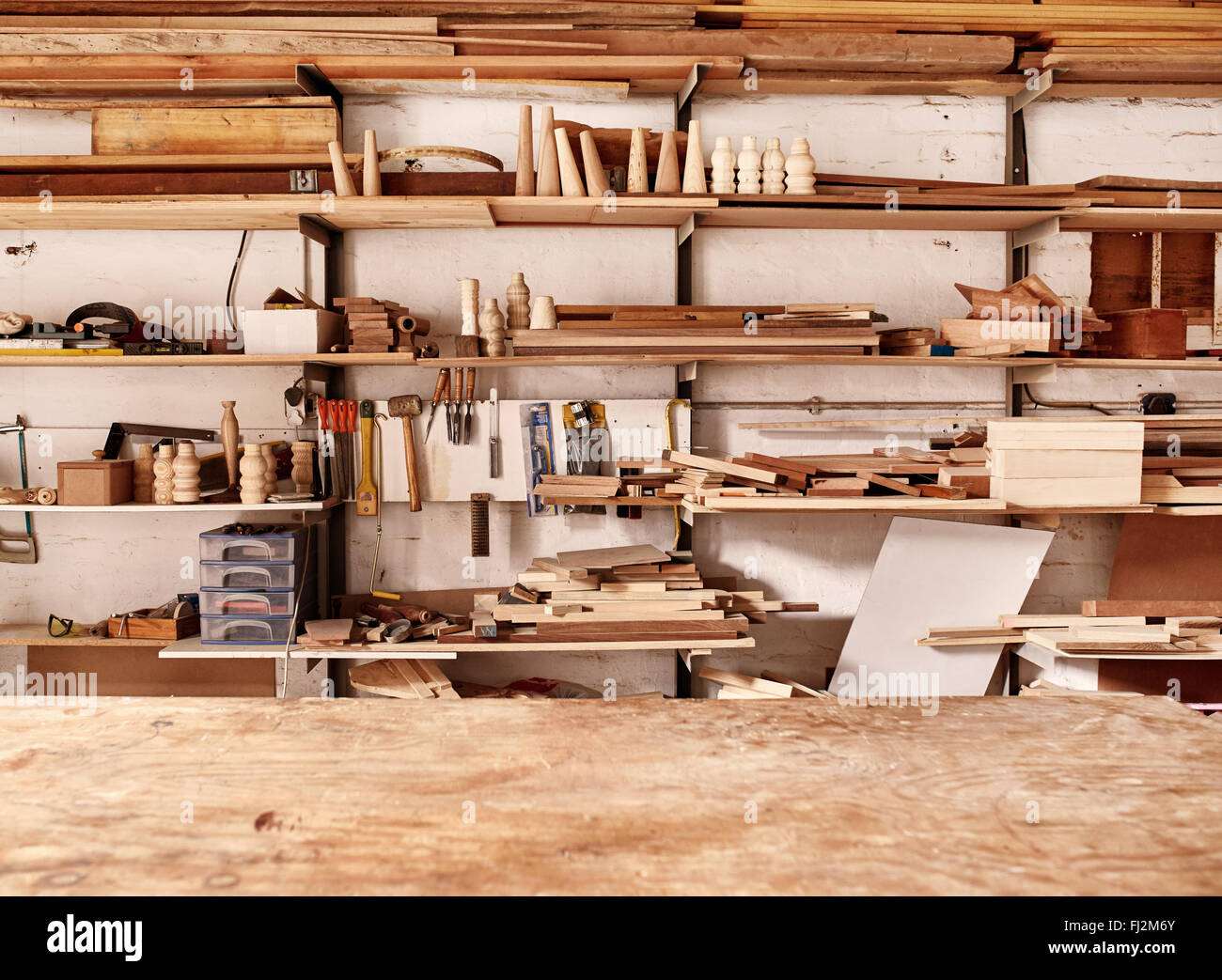 Shelves in woodwork workshop with various wooden items and tools Stock ...