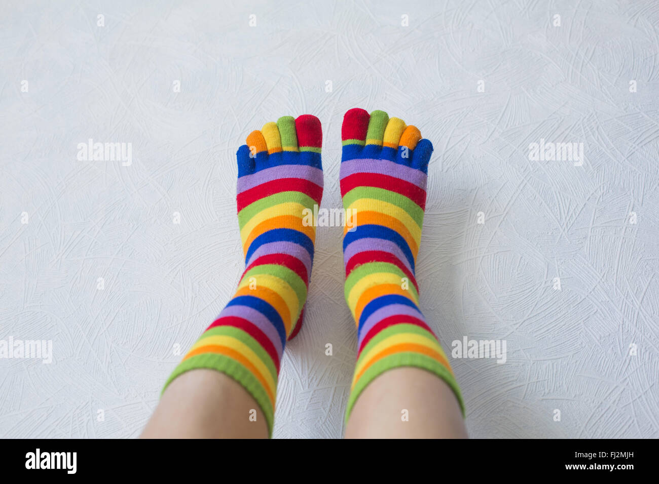 Close-up photo woman's feet in multi color socks Stock Photo - Alamy