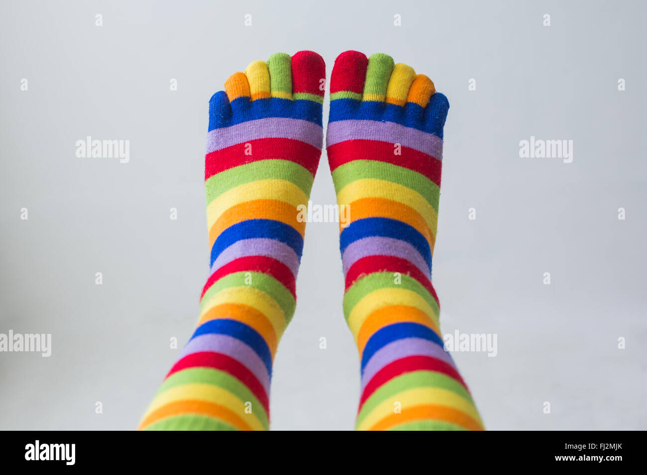 Close-up photo woman's feet in multi color socks Stock Photo - Alamy