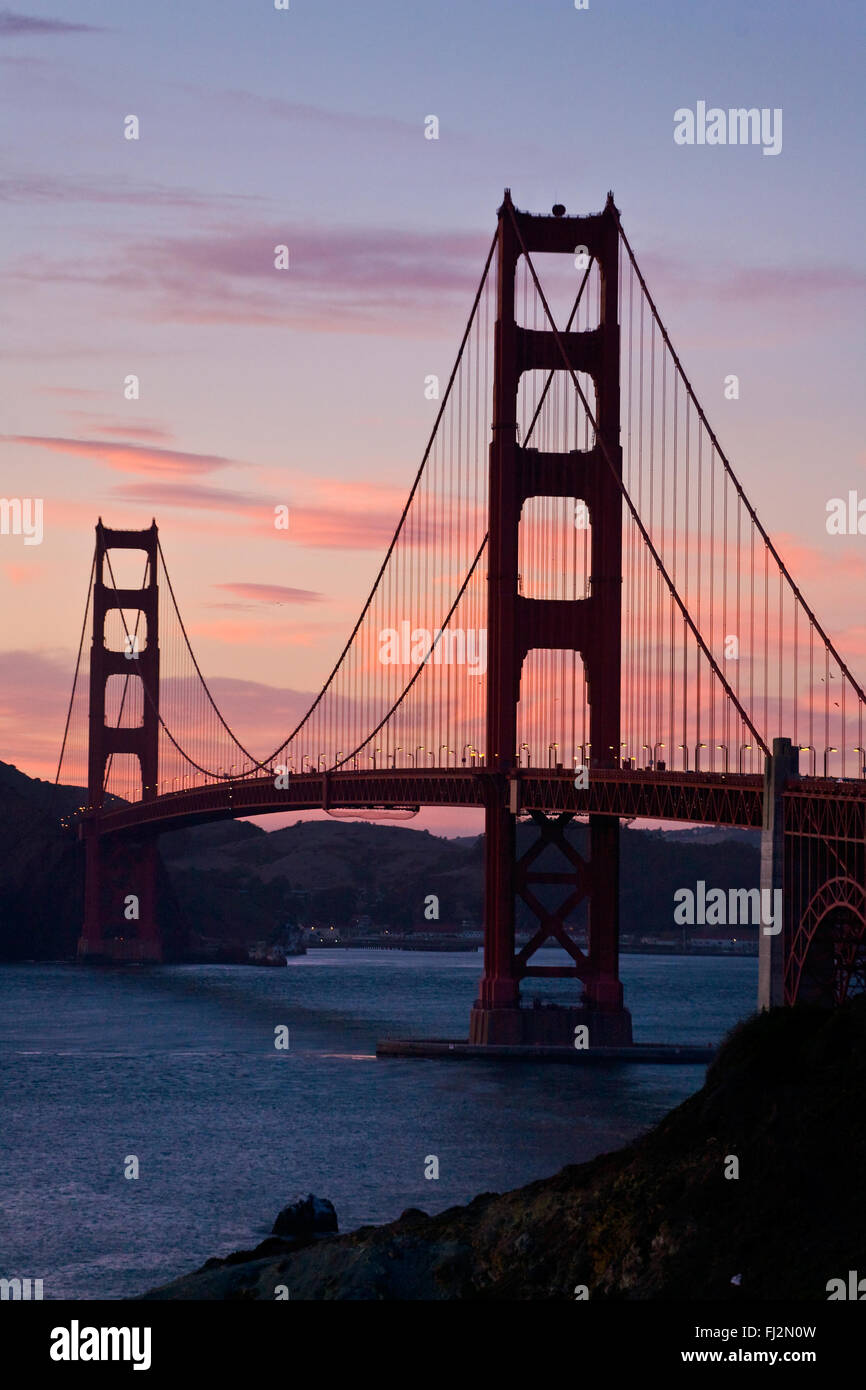 THE GOLDEN GATE BRIDGE at sunset from the cliffs above BAKER BEACH ...