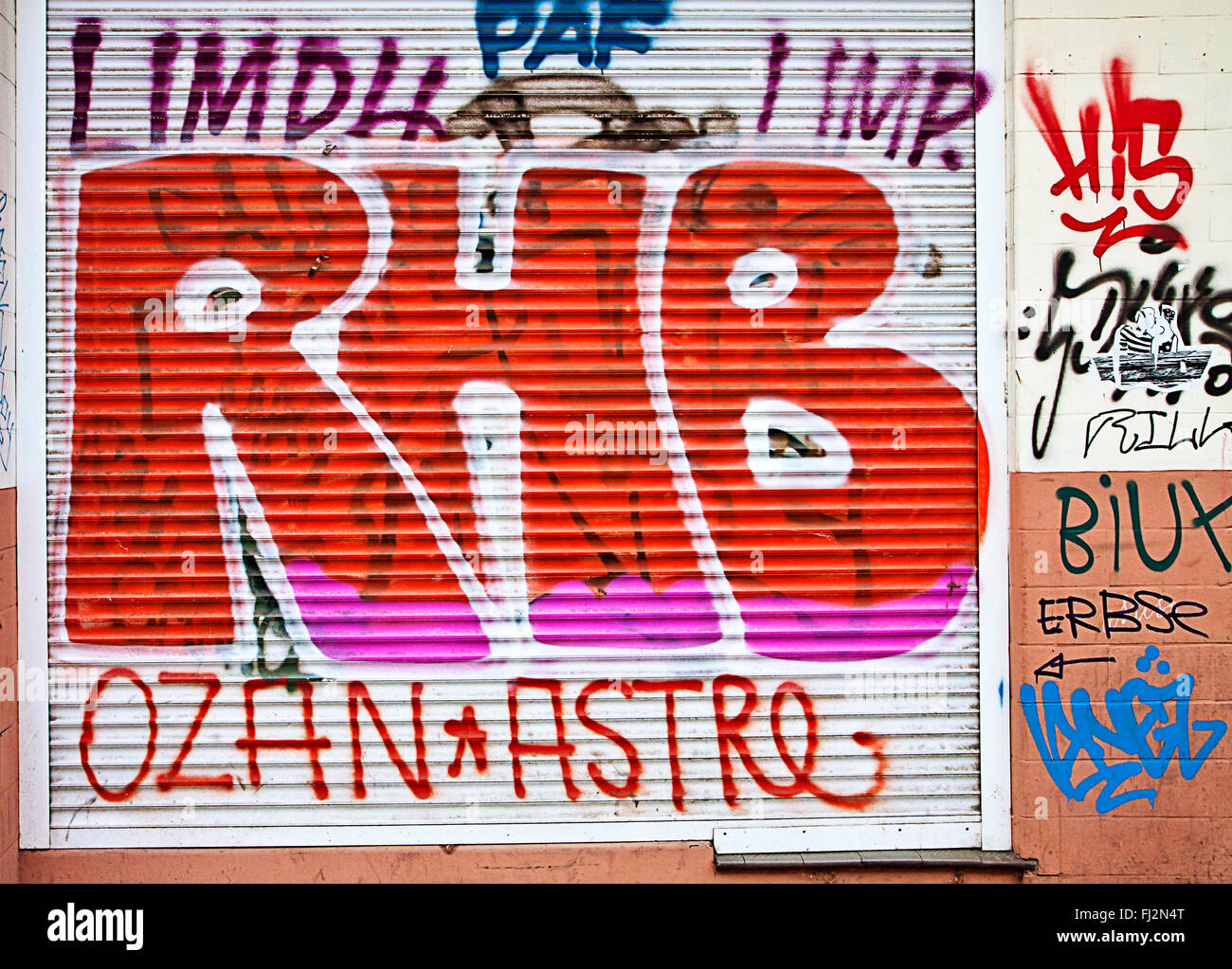 Berlin, roller blind of store with street art graffiti Stock Photo - Alamy