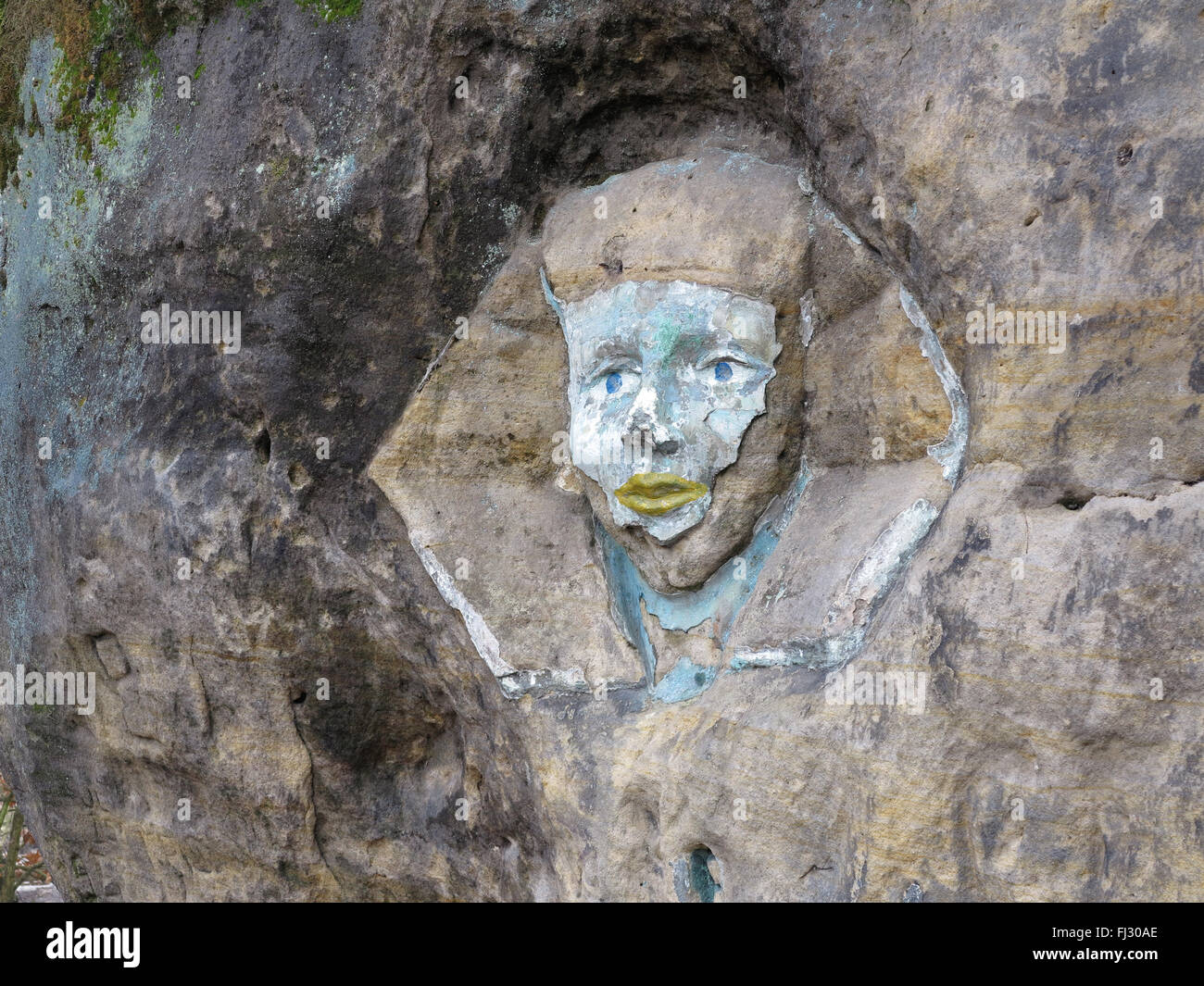 Rock relief - the face of the Sphinx - carved into the sandstone cliff ...