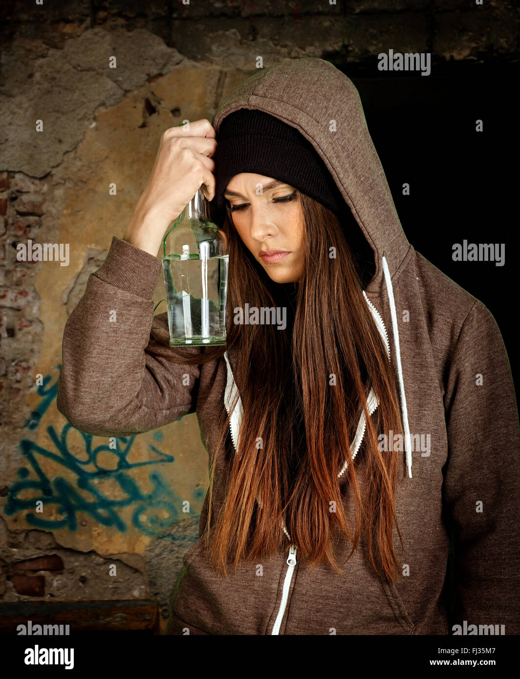 Drunk girl holding bottle of vodka Stock Photo - Alamy