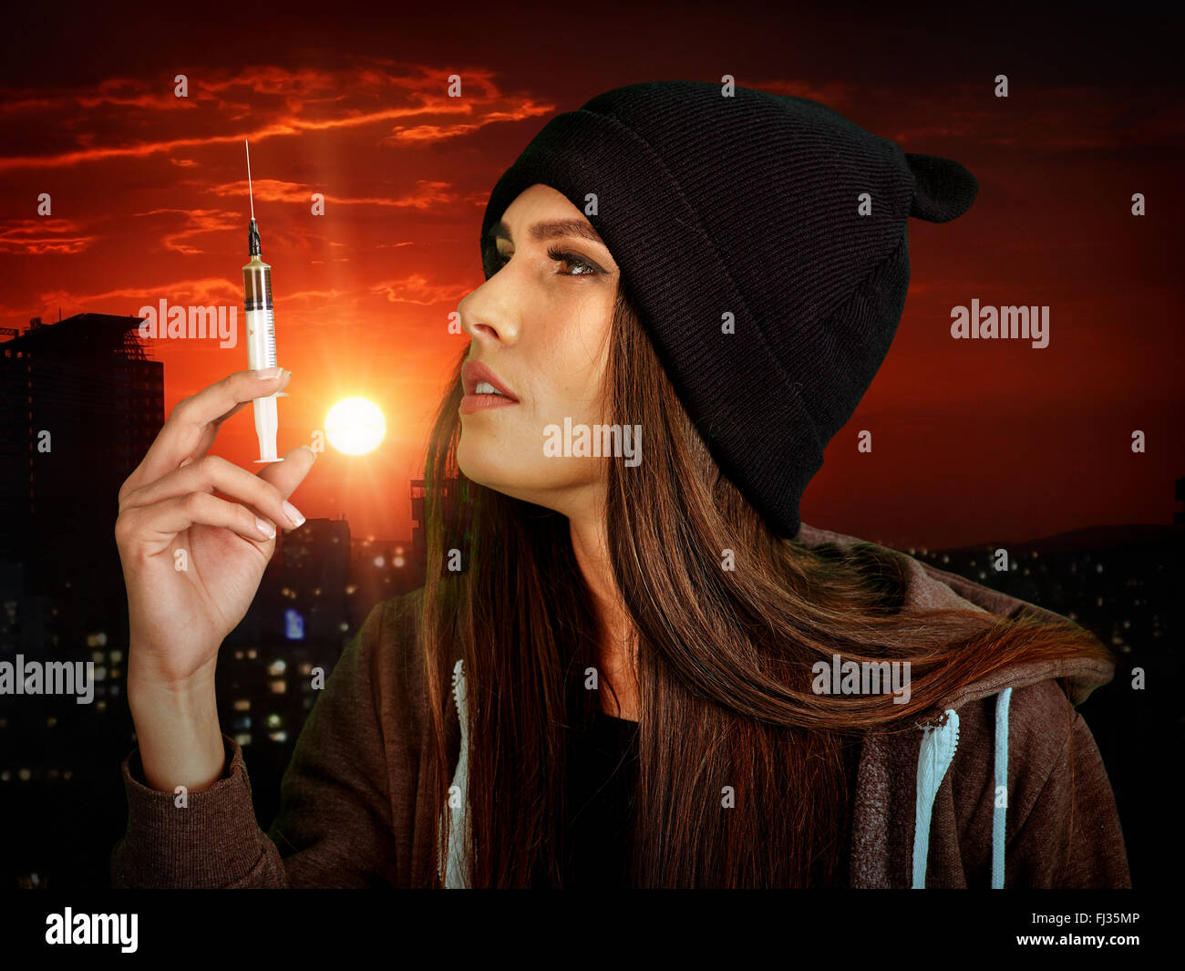 Woman addicted to syringe on sunset background Stock Photo - Alamy