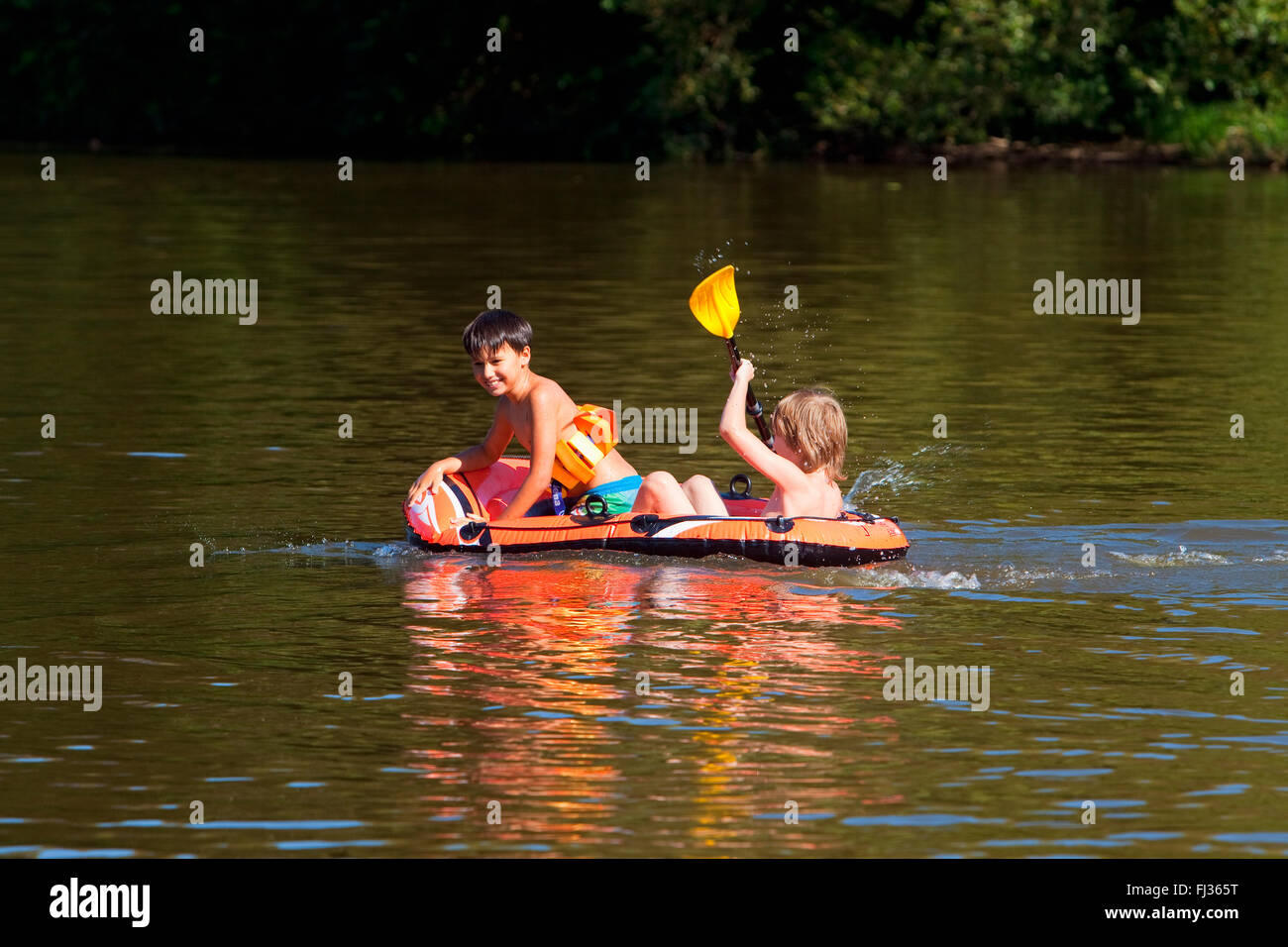 Two Boys Having Fun on Inflatable Rubber Boat in Summer Stock Photo - Alamy