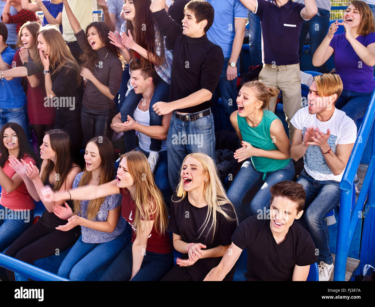 Sport fans clapping and singing on tribunes Stock Photo - Alamy