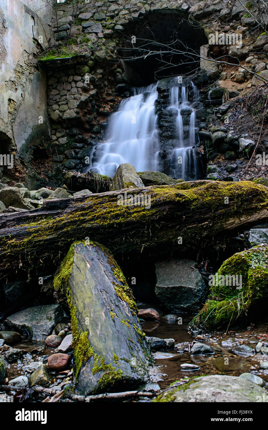 Waterfall from the arch made of stones Stock Photo - Alamy