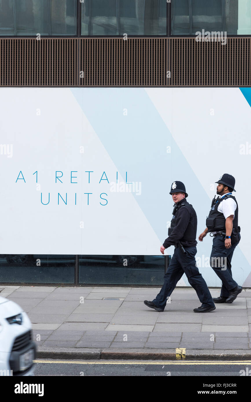 Two Police Constables, of the Metropolitan Police Service, walk along ...
