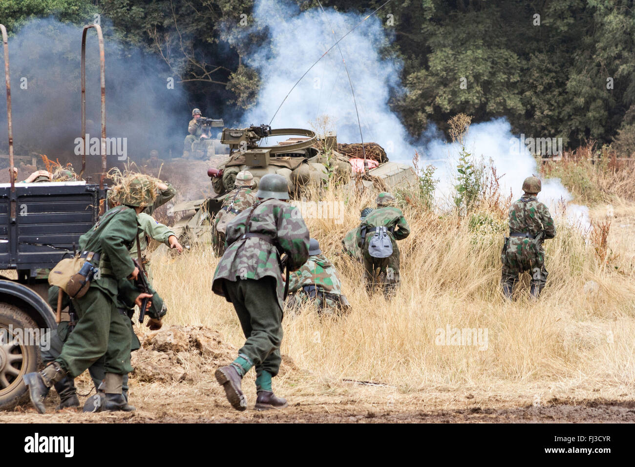 Second world war re-enactment. German battle group in camouflage ...