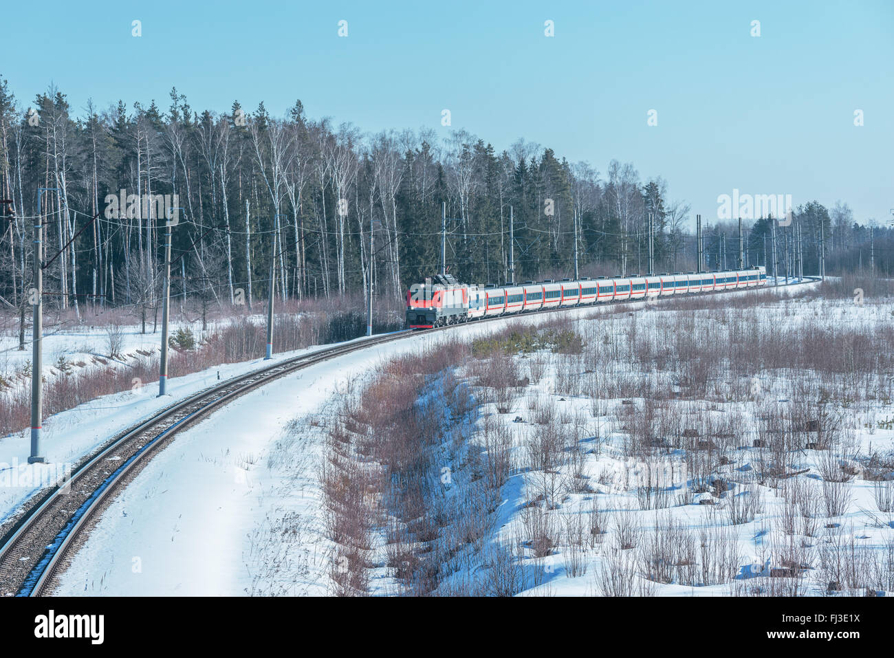 Modern high-speed train moves fast at day winter time Stock Photo - Alamy
