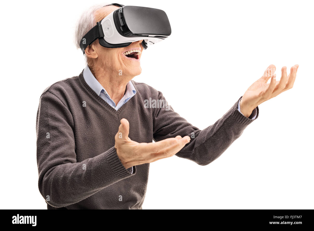 Amazed senior gentleman using a VR headset and gesturing with his hands ...
