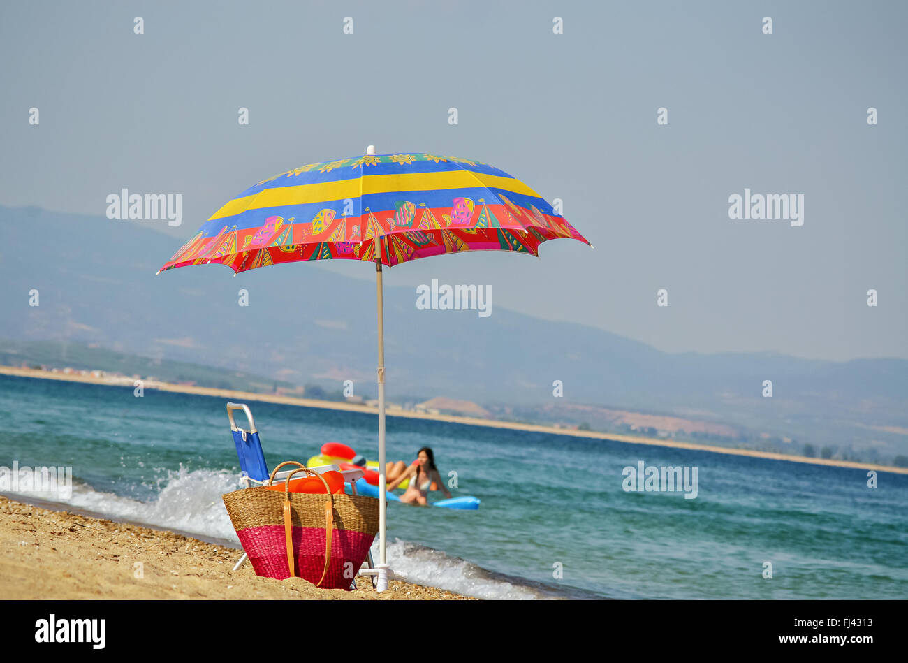 Single parasol on the beach during summer holidays Stock Photo - Alamy
