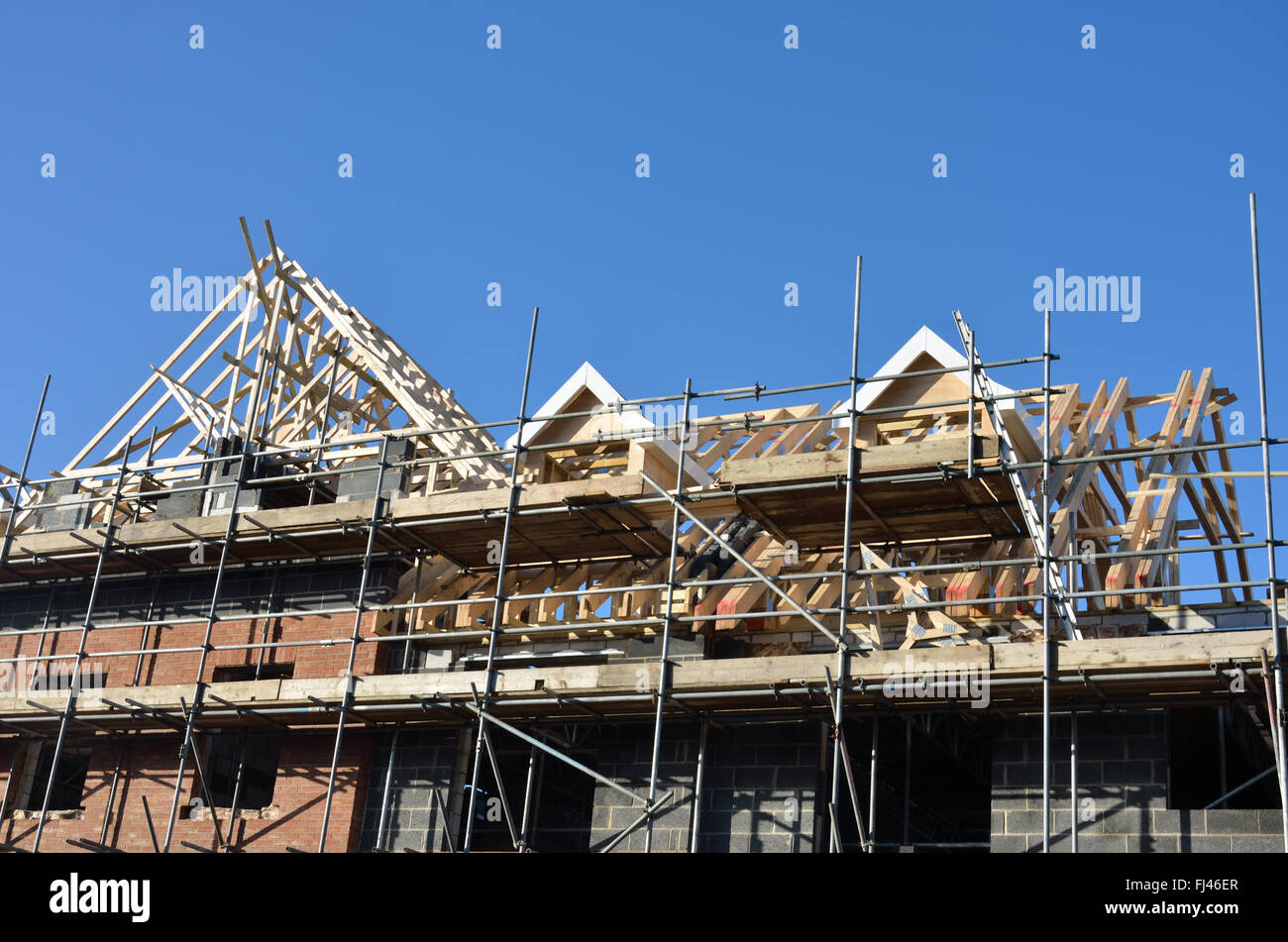 Roof under construction under blue sky Stock Photo - Alamy
