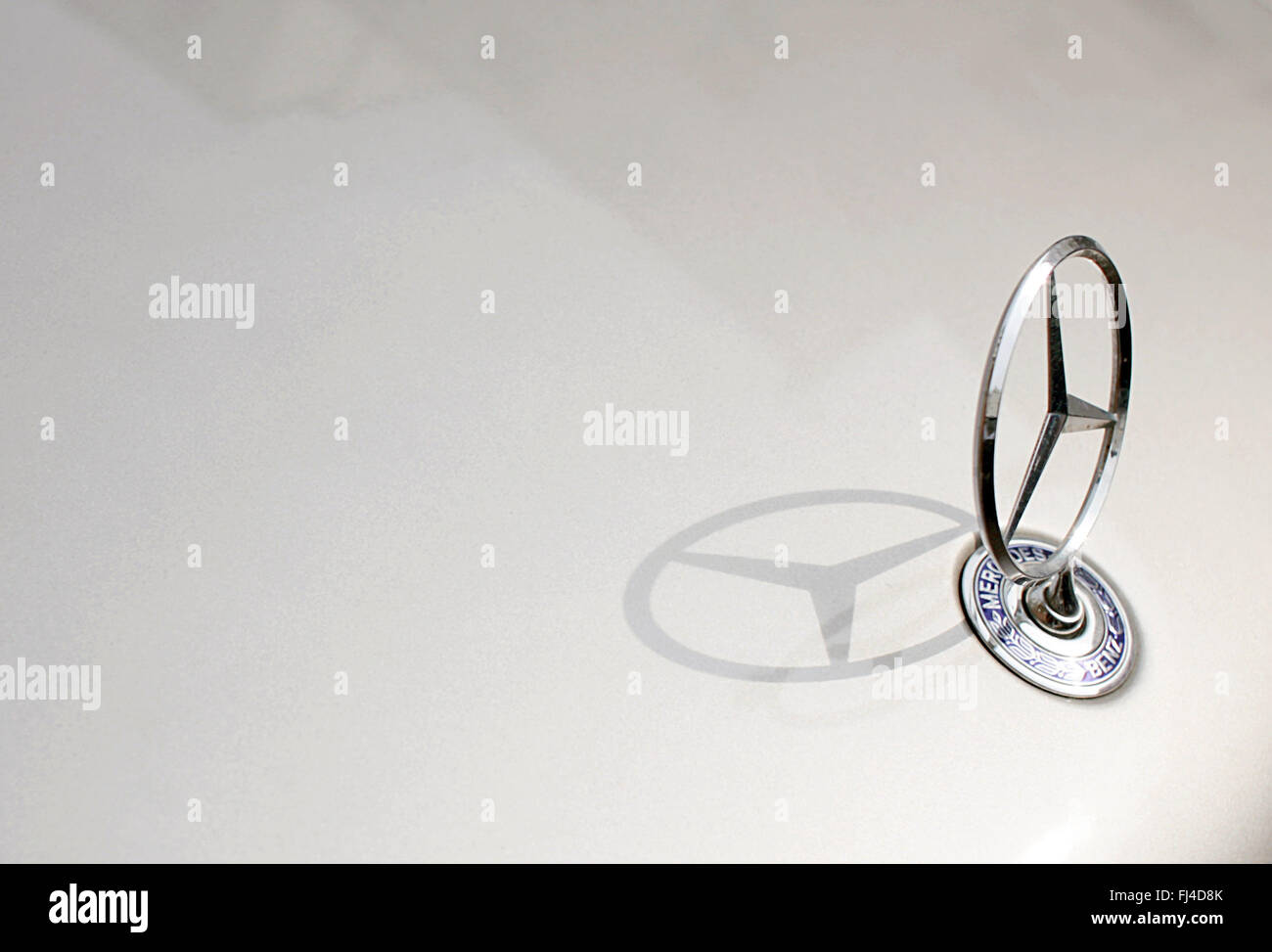 The company logo of Mercedes-Benz, a three armed star inside a ring ...