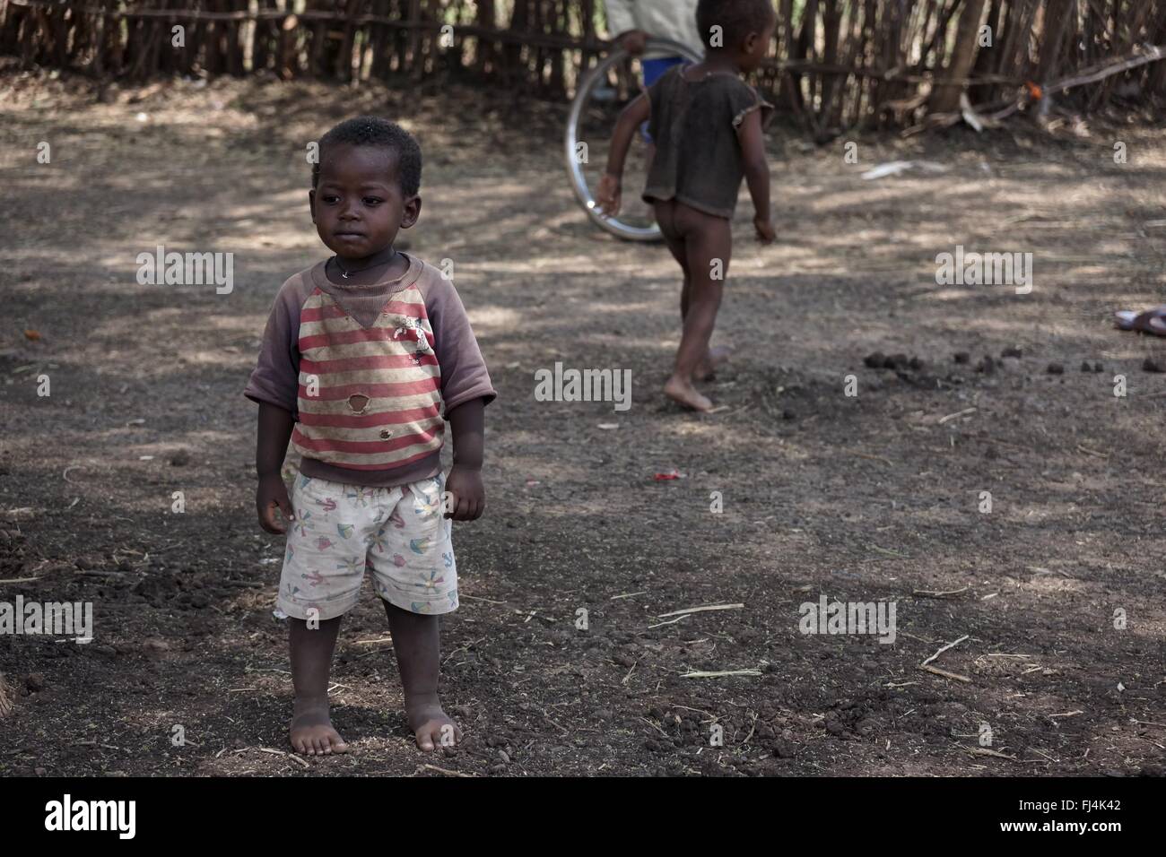 A young boy stares out at the passing people Stock Photo - Alamy