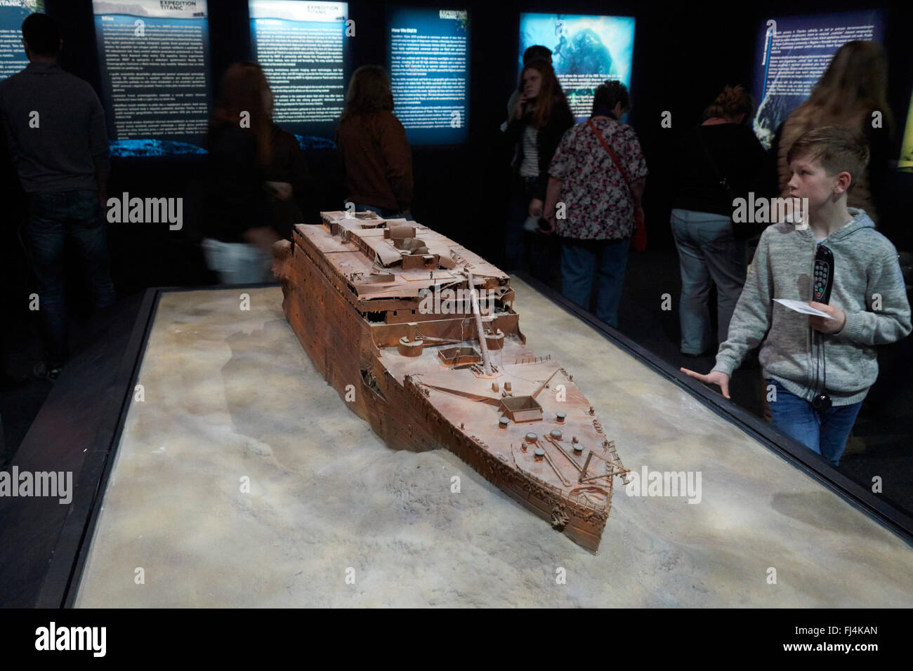 A visitor looks at authentic objects from the Titanic at the exhibition ...