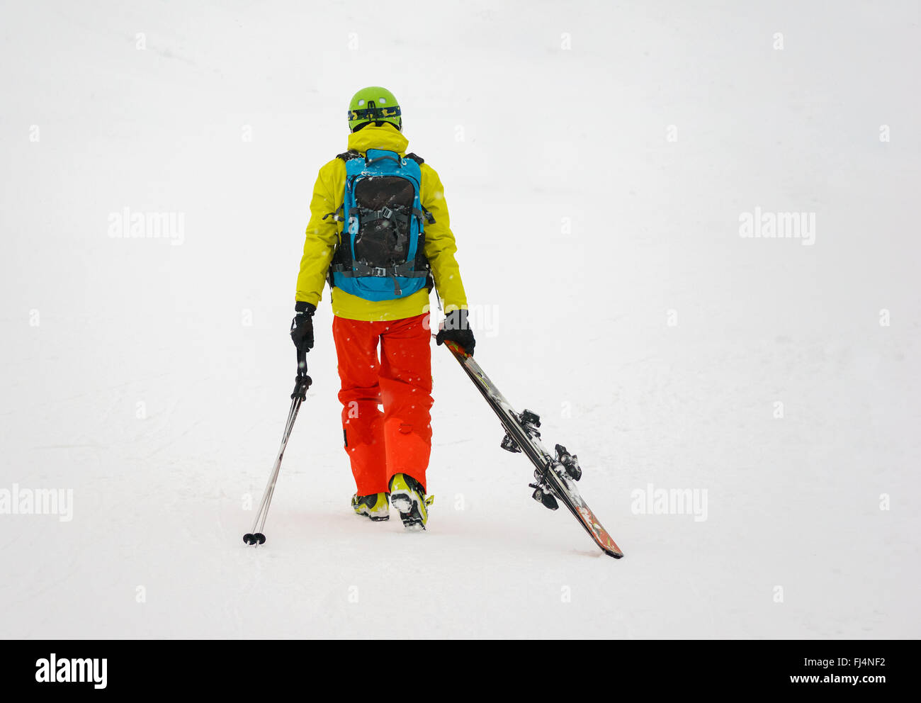 Sad and weary skier goes away, dragging skis Stock Photo - Alamy