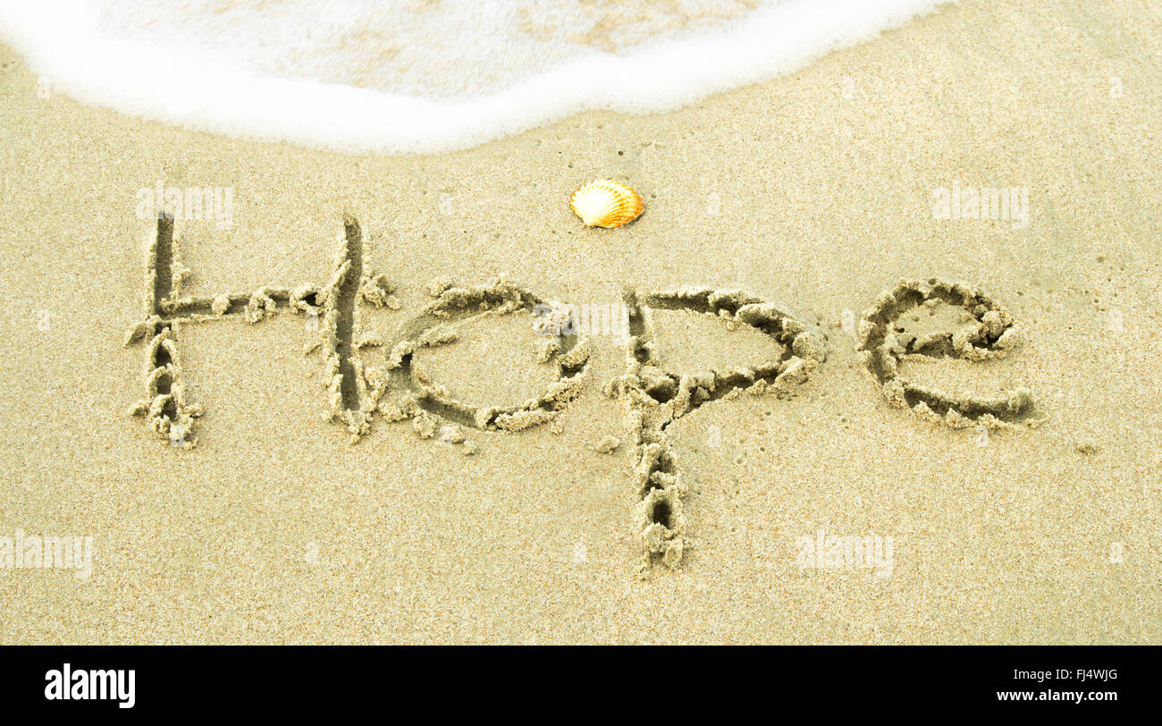 Word "Hope" handwritten in sand at beach Stock Photo - Alamy