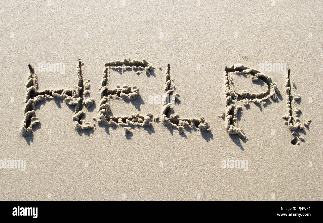 Help written on sand beach Stock Photo - Alamy