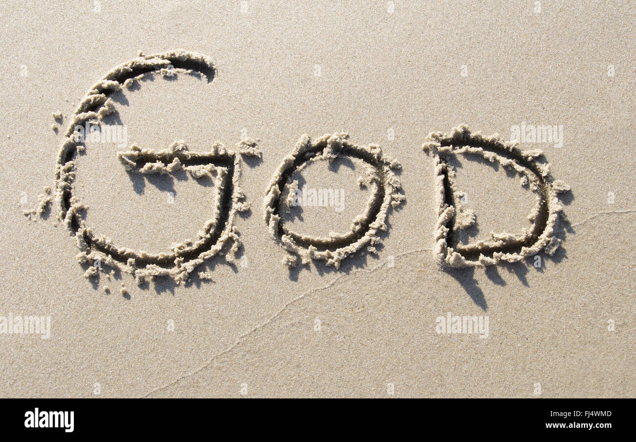"God" written on sand beach Stock Photo - Alamy