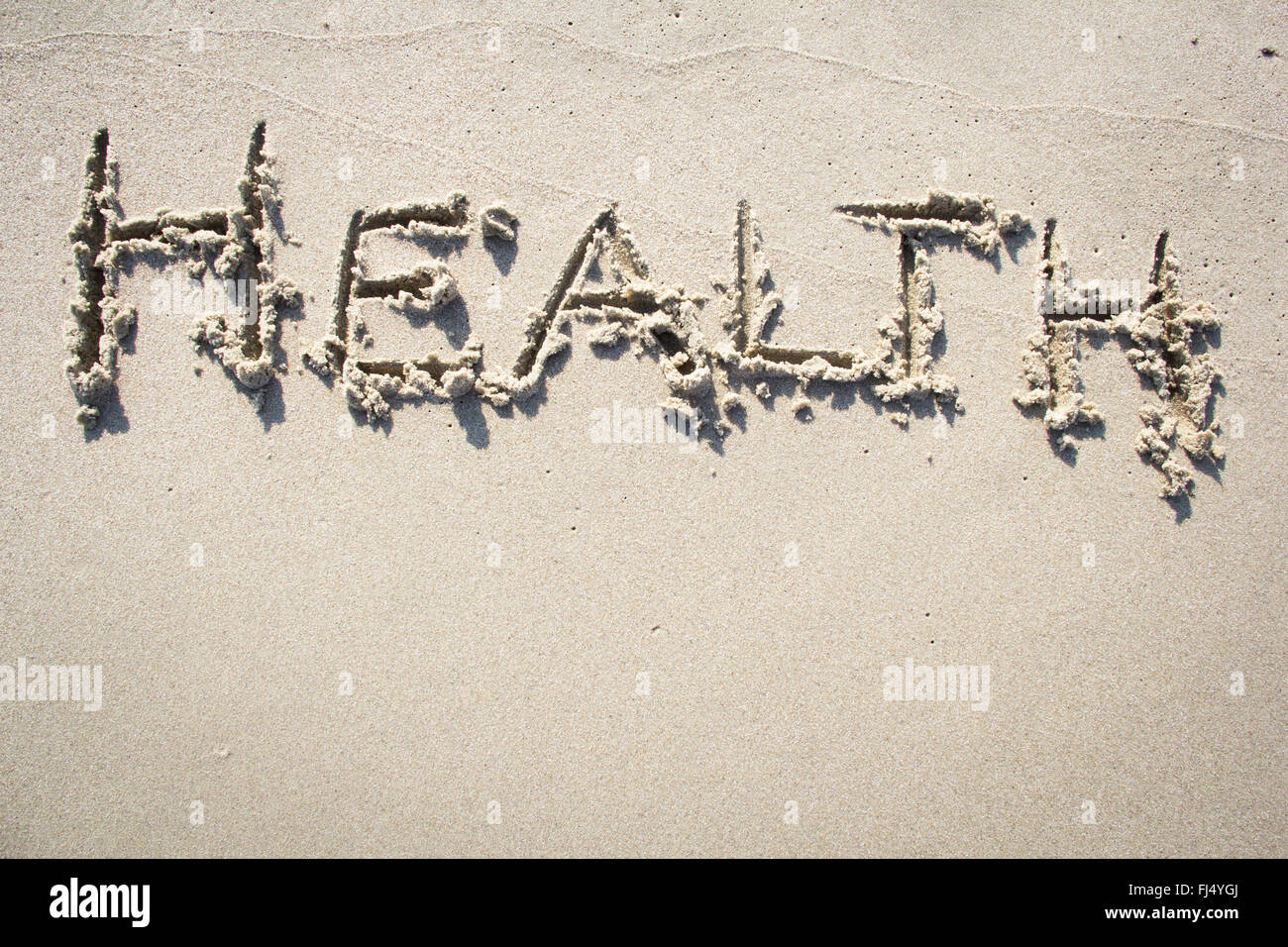 "Health" written in sand Stock Photo - Alamy