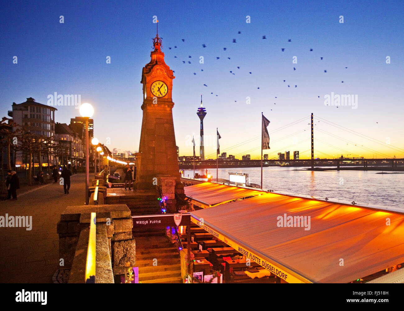 Rhine river promenade with gauge tower and Rheinturm, Germany, North ...