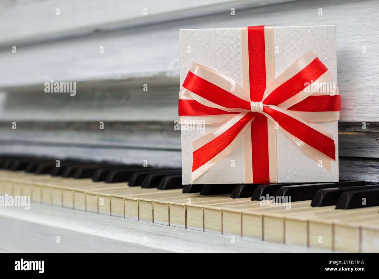 gift with a red bow is on the keys Stock Photo - Alamy