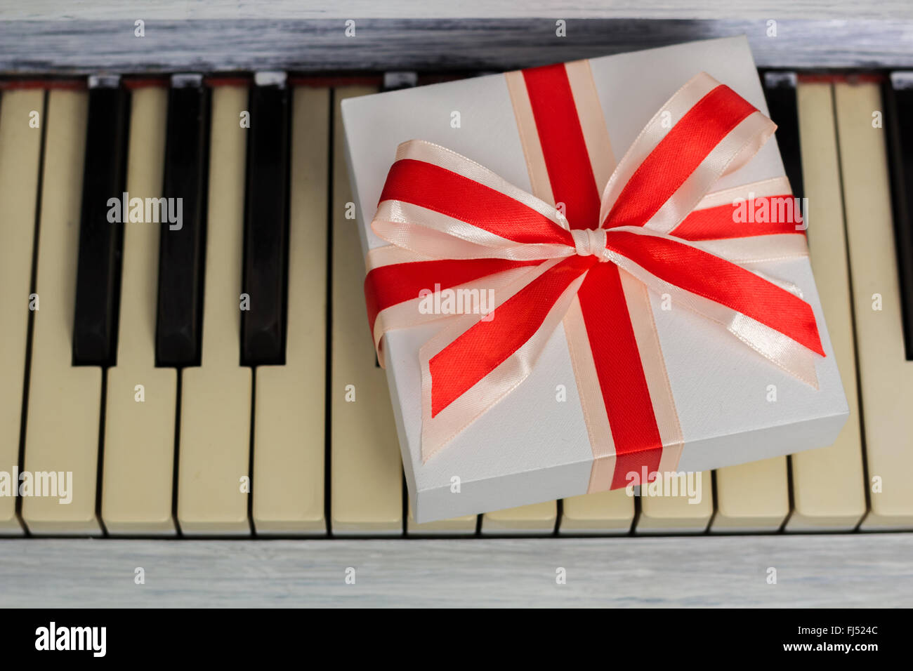 gift with a red bow is on the keys Stock Photo - Alamy