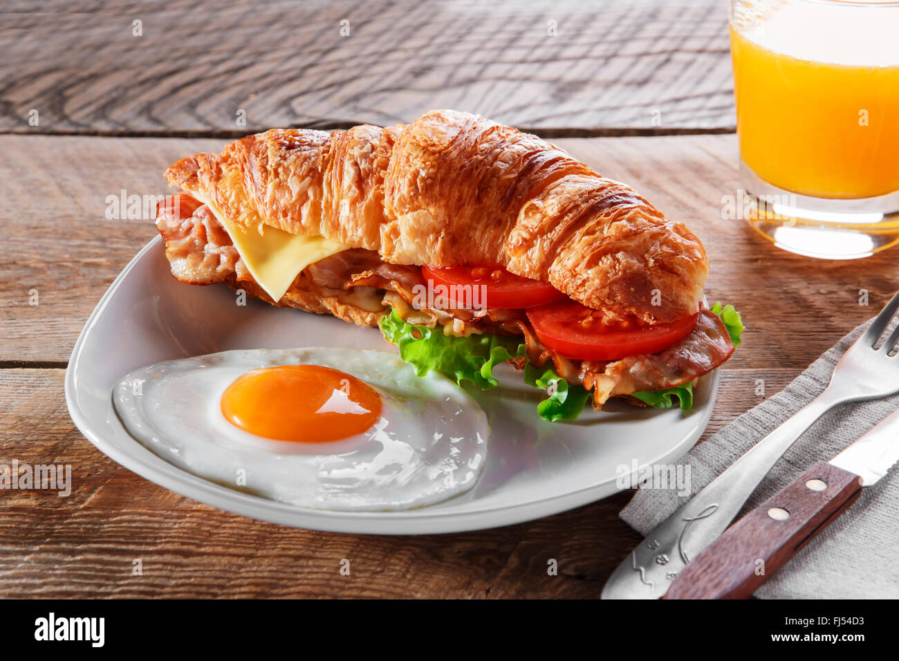 sandwich croissant with fried bacon cheese tomato breakfast and egg ...