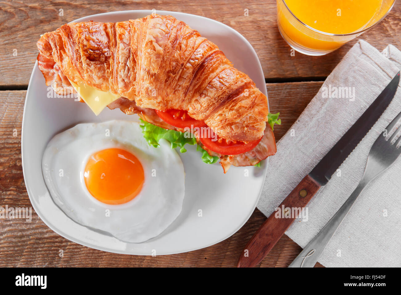sandwich croissant with fried bacon cheese tomato breakfast and egg ...