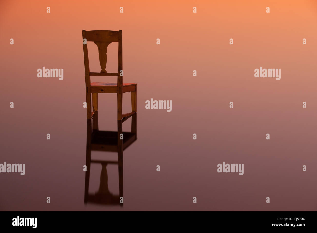 Wooden chair on the surface of a pond at sunset Stock Photo - Alamy