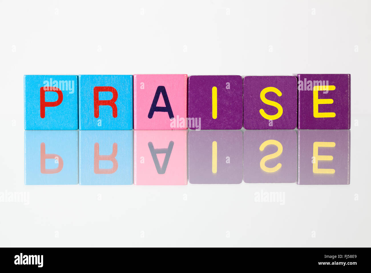 Praise - an inscription from children's wooden blocks Stock Photo - Alamy