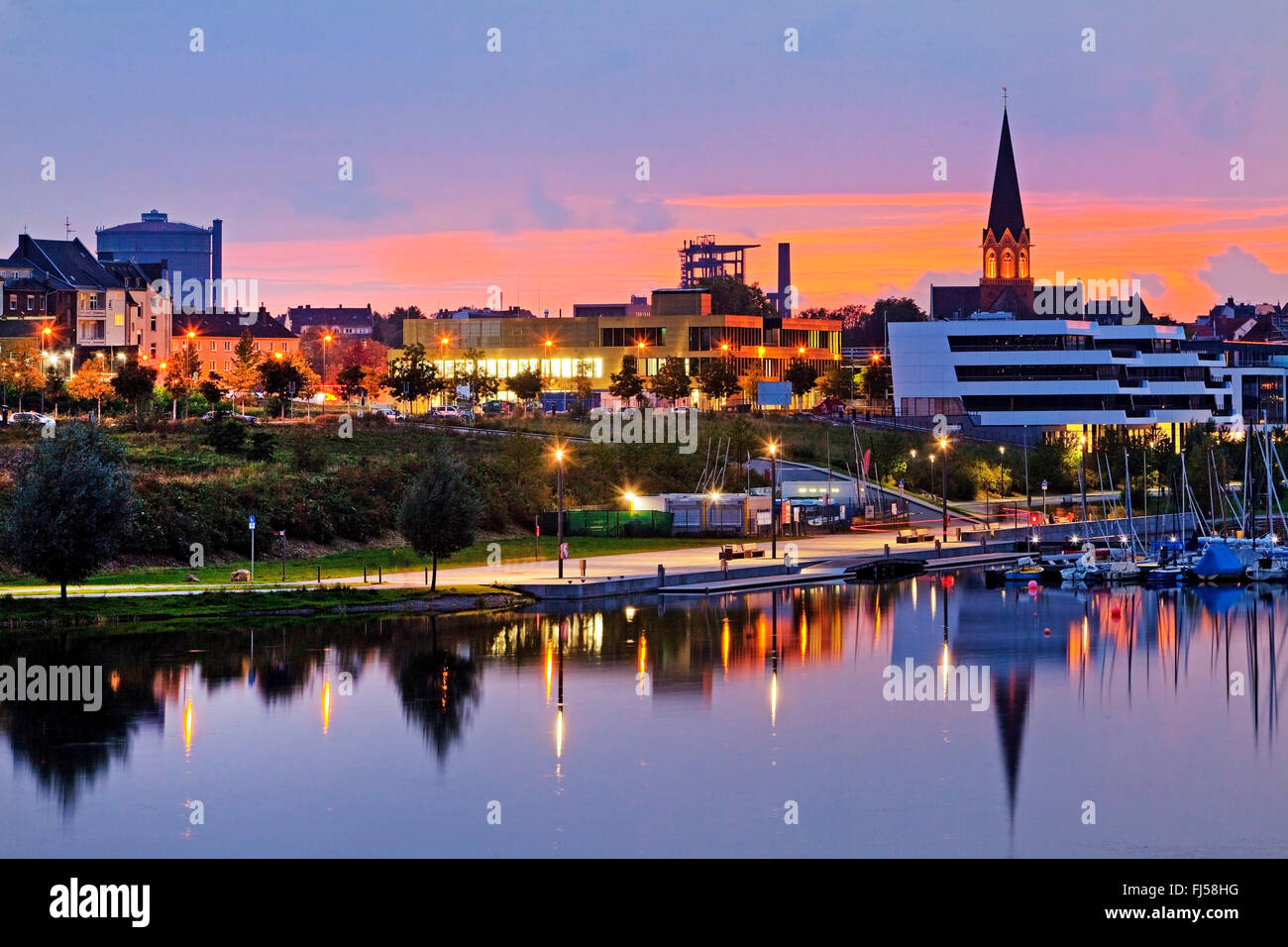 Lake Phoenix with blast furnace and steeple in the evening, Germany ...