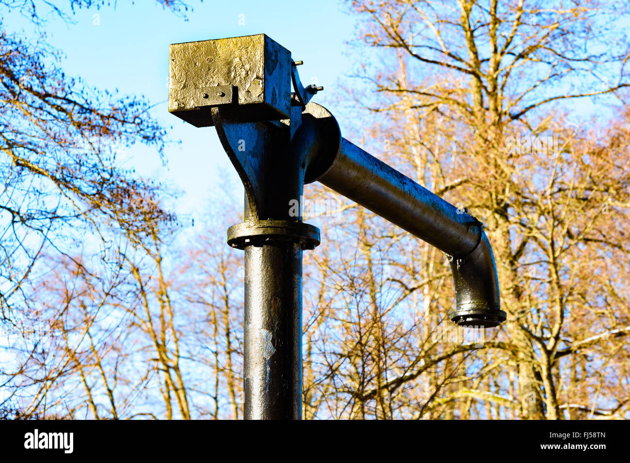 A black cast iron water outlet to fill steam trains with. Sky and ...