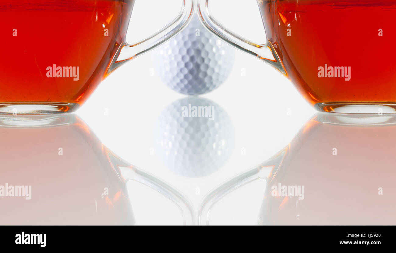Two cups of tea and golf ball on the glass table Stock Photo - Alamy