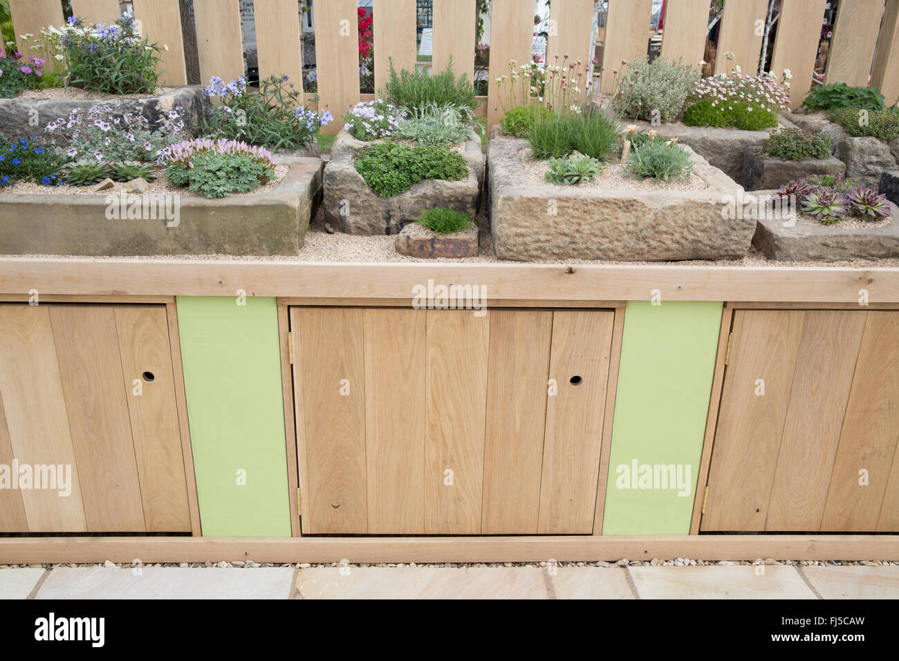 Patio with a rock garden with alpine plants plant in stone containers ...
